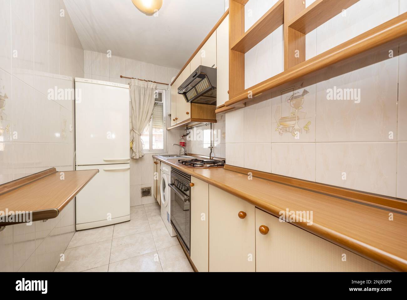 Kitchen with light-colored furniture with wooden ball handles to match ...