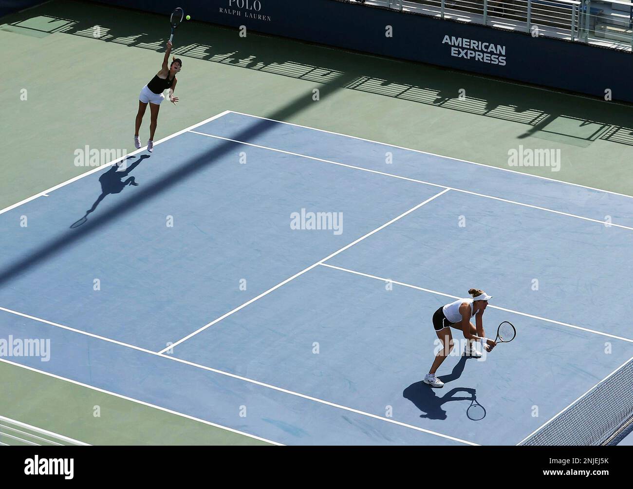 Anna Danilina serves during a women's doubles match at the 2022 US Open ...