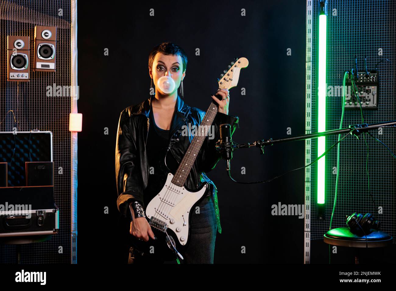 Rockstar guitarist holding electric guitar while playing rock music in ...