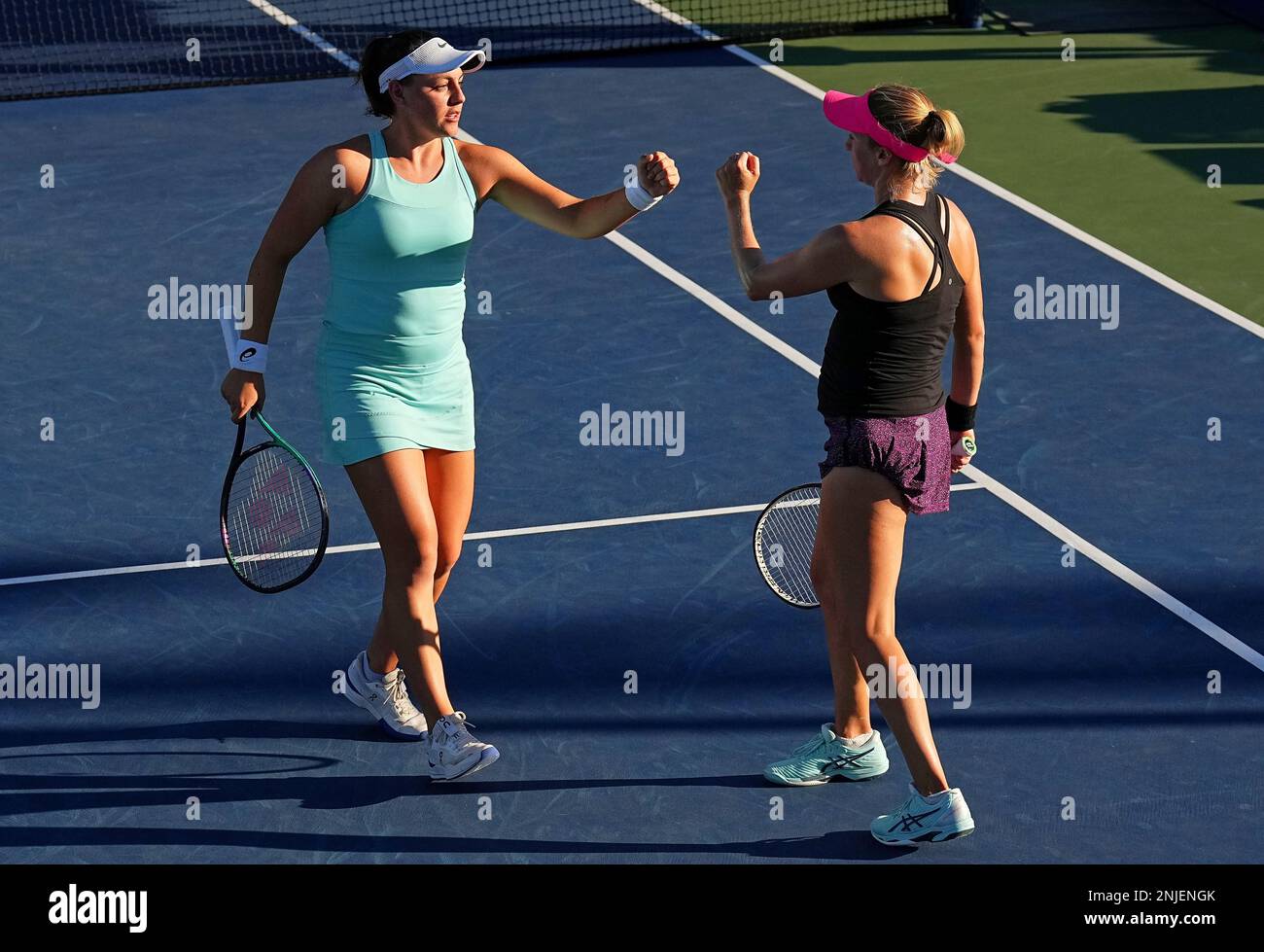Ingrid Neel and Catherine Harrison fist bump during a women's doubles ...