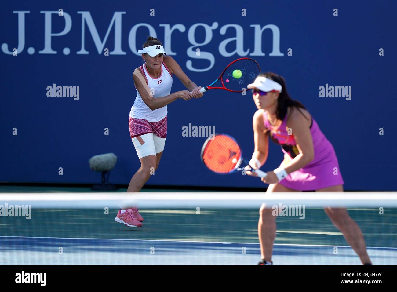Evgeniya Rodina and Xinyun Han in action during a women's doubles match ...