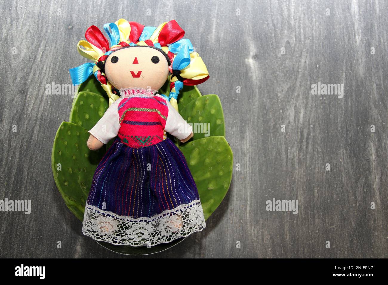 Festive Mexican objects: handmade doll and tricolor tie bow next to ...