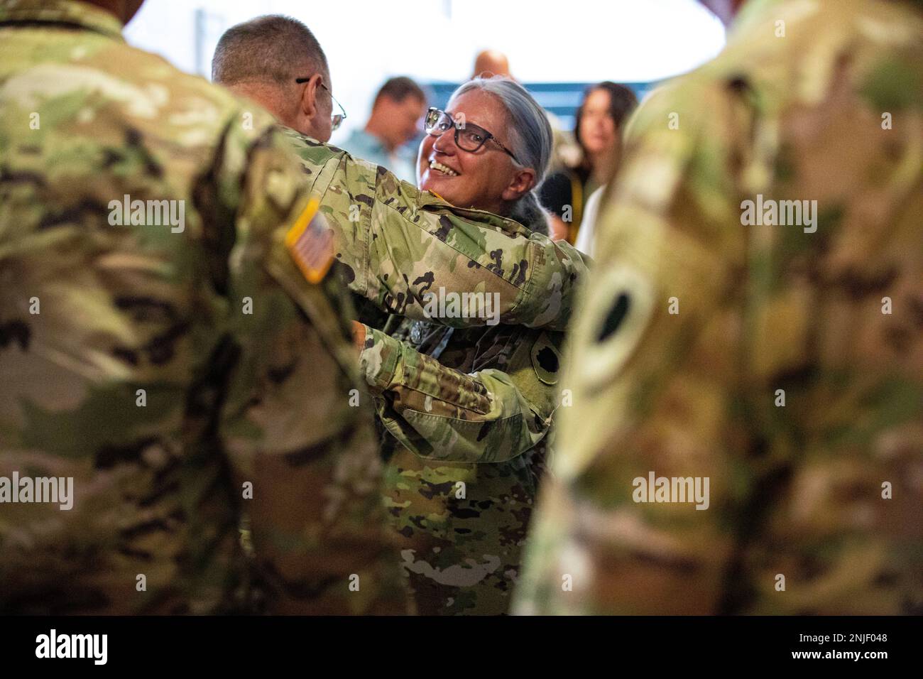 Chief Warrant Officer (4) Peggy Bates hugs friends after her retirement ...