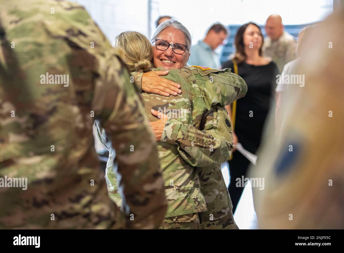 Chief Warrant Officer (4) Peggy Bates hugs friends after her retirement ...