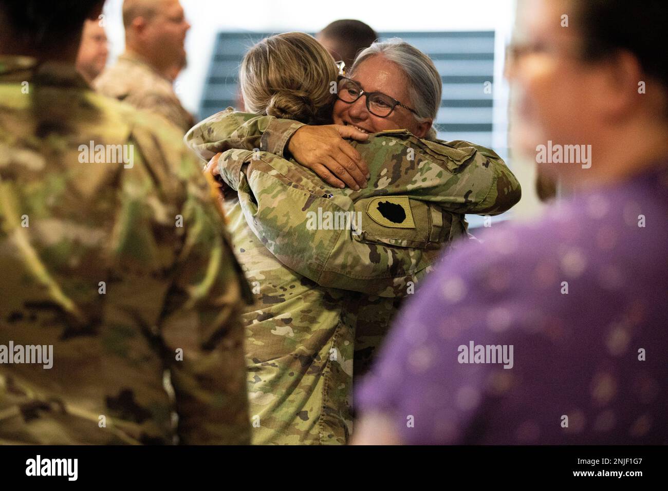 Chief Warrant Officer (4) Peggy Bates hugs friends after her retirement ...