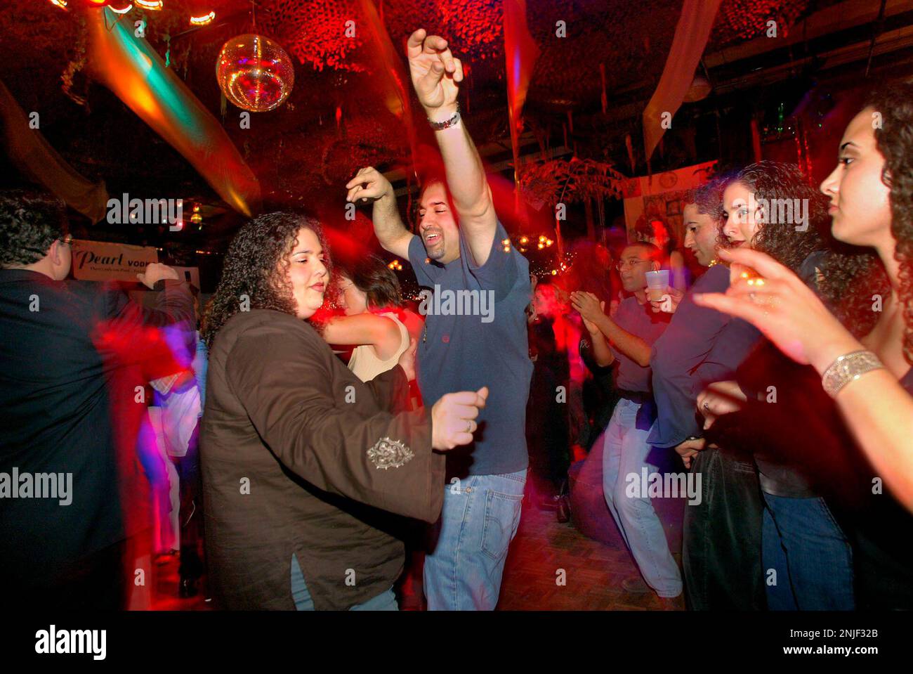 ARAB16-C-21MAR03-DD-LH--DJ Nader (Michael Nader Musleh) dancing with ...