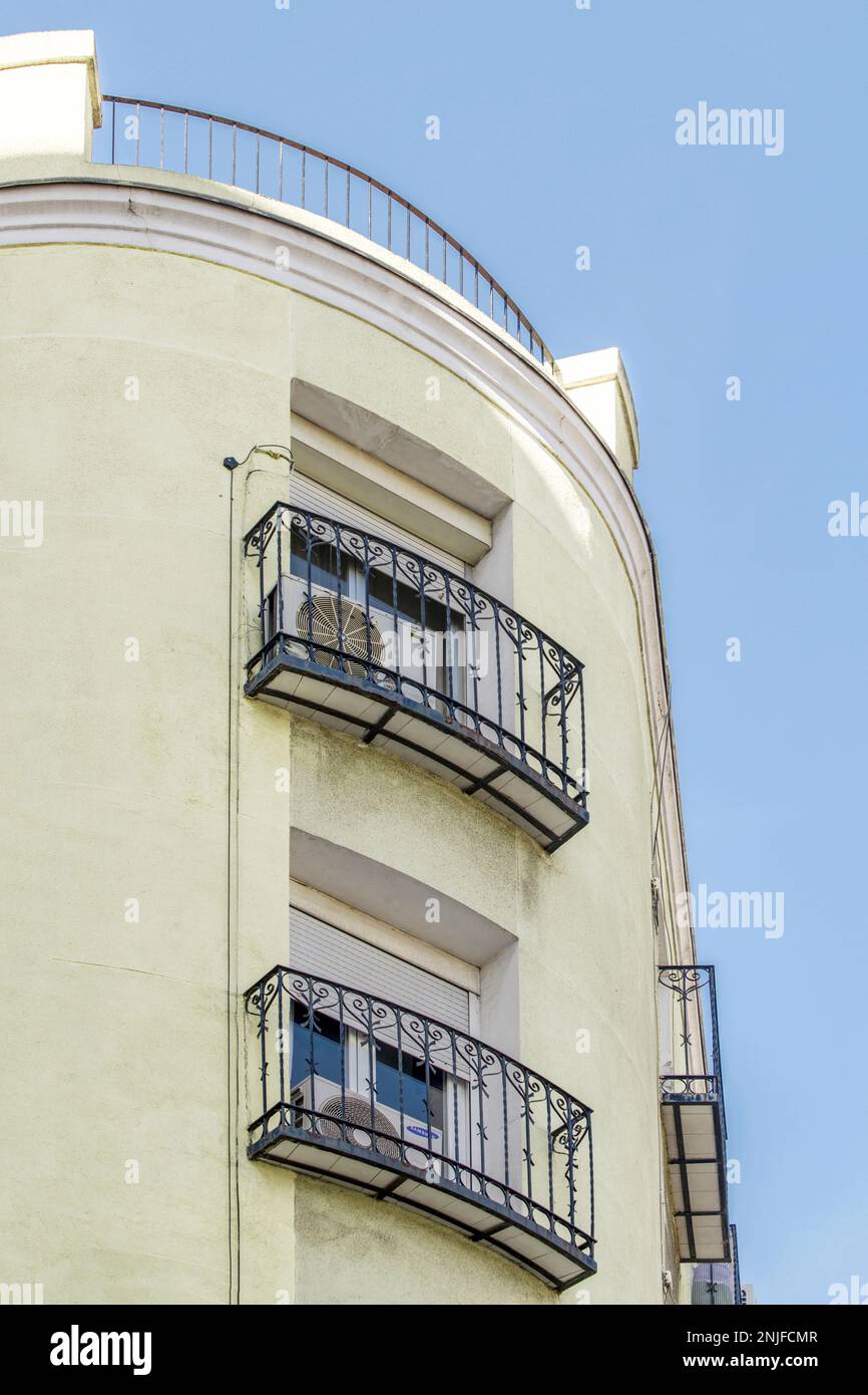 Curved facade of a residential building with wrought iron metal ...