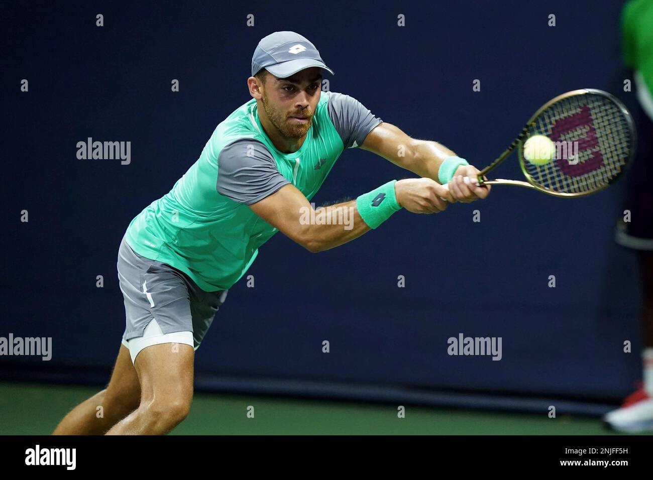 Benjamin Bonzi returns during a men's singles match at the 2022 US Open ...