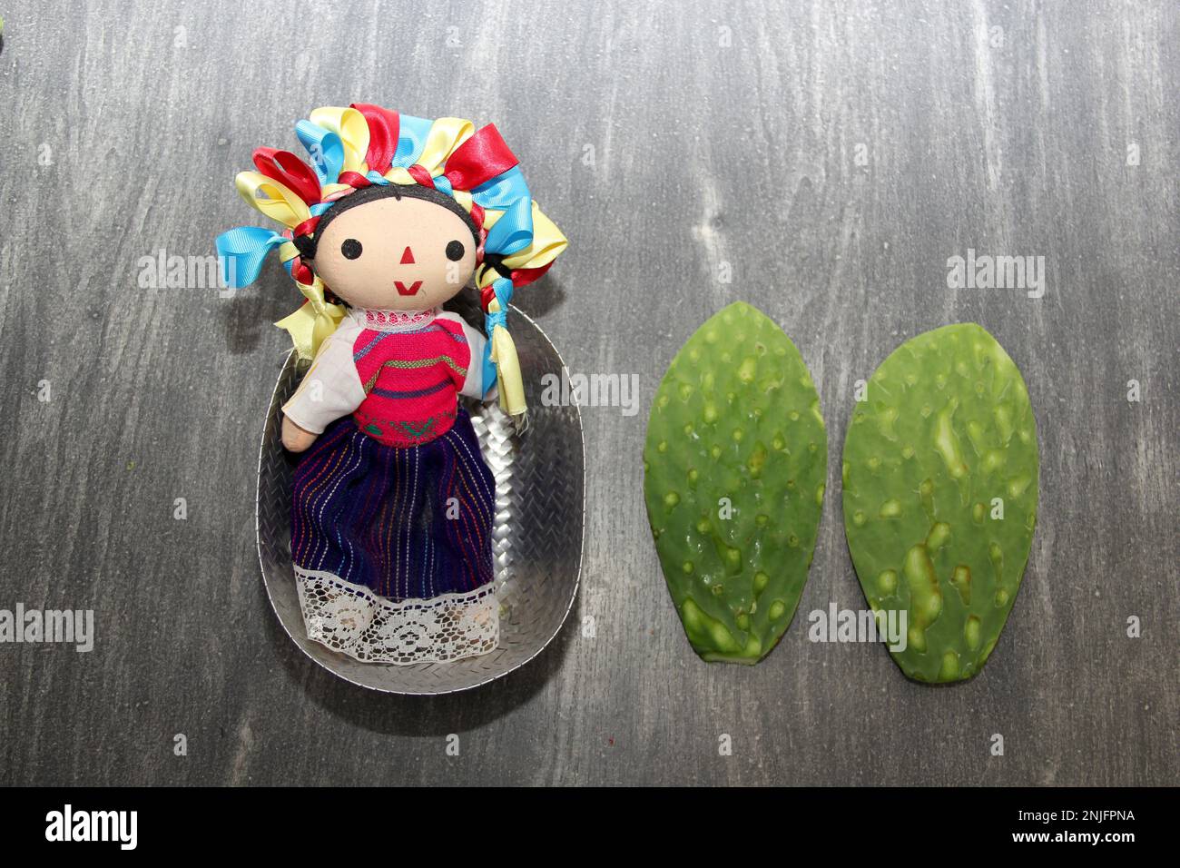 Festive Mexican objects: handmade doll and tricolor tie bow next to ...