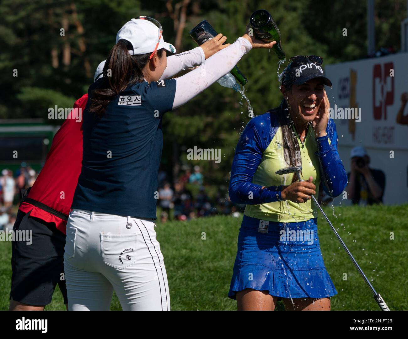 Paula Reto, from South Africa, laughs as she is sprayed with champagne ...