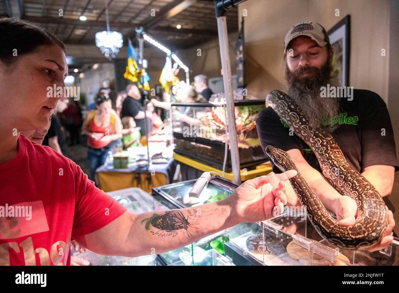 Tracy Fleck of Brunswick pets a snake held by Nelson Horton of ...