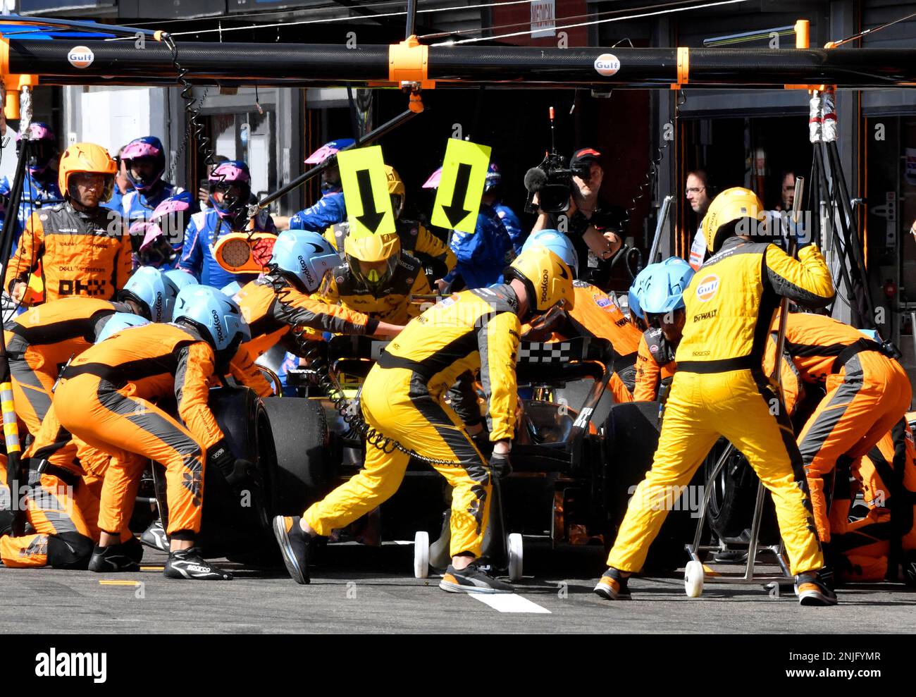 Pit crew work on the car of McLaren driver Daniel Ricciardo of ...