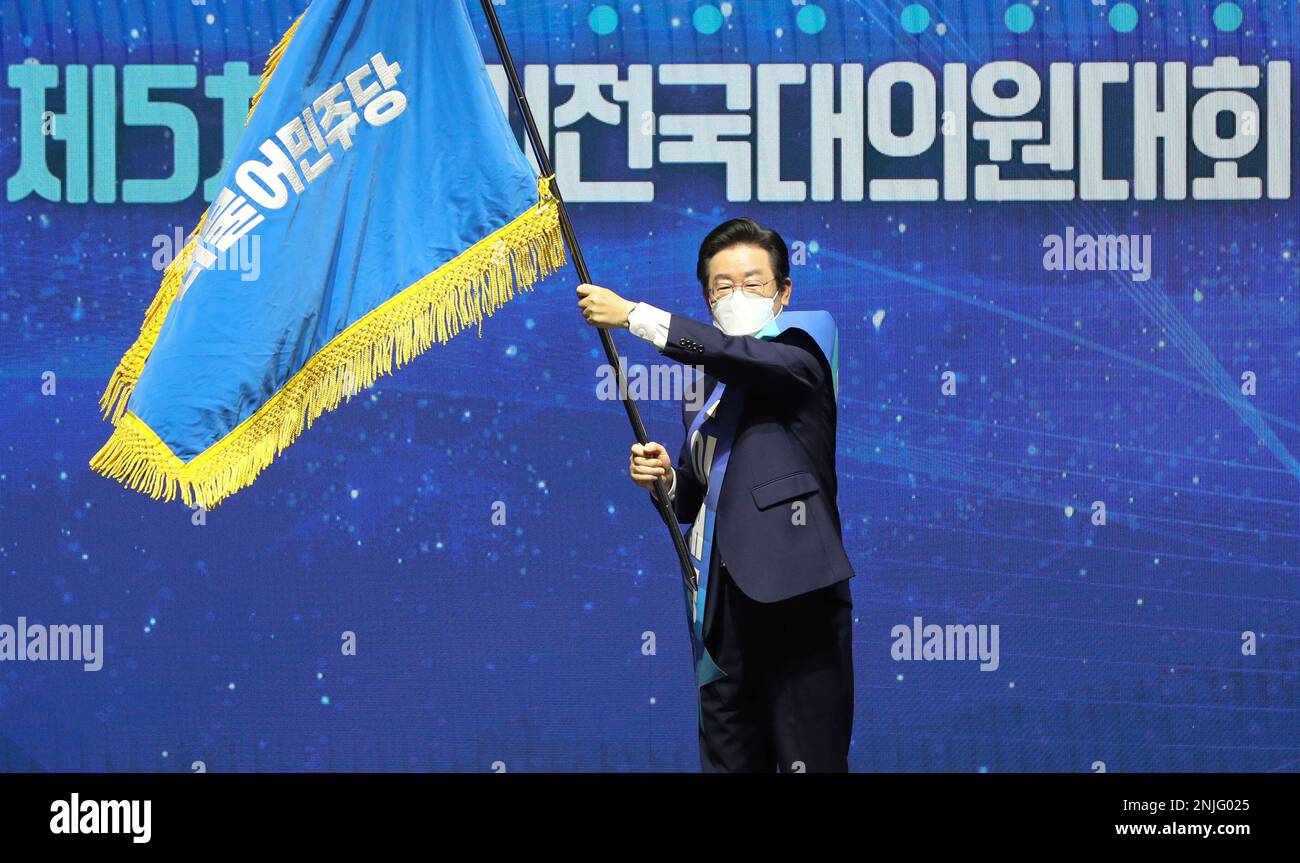 South Korean lawmaker Lee Jae-myung waves the party's flag after he was ...