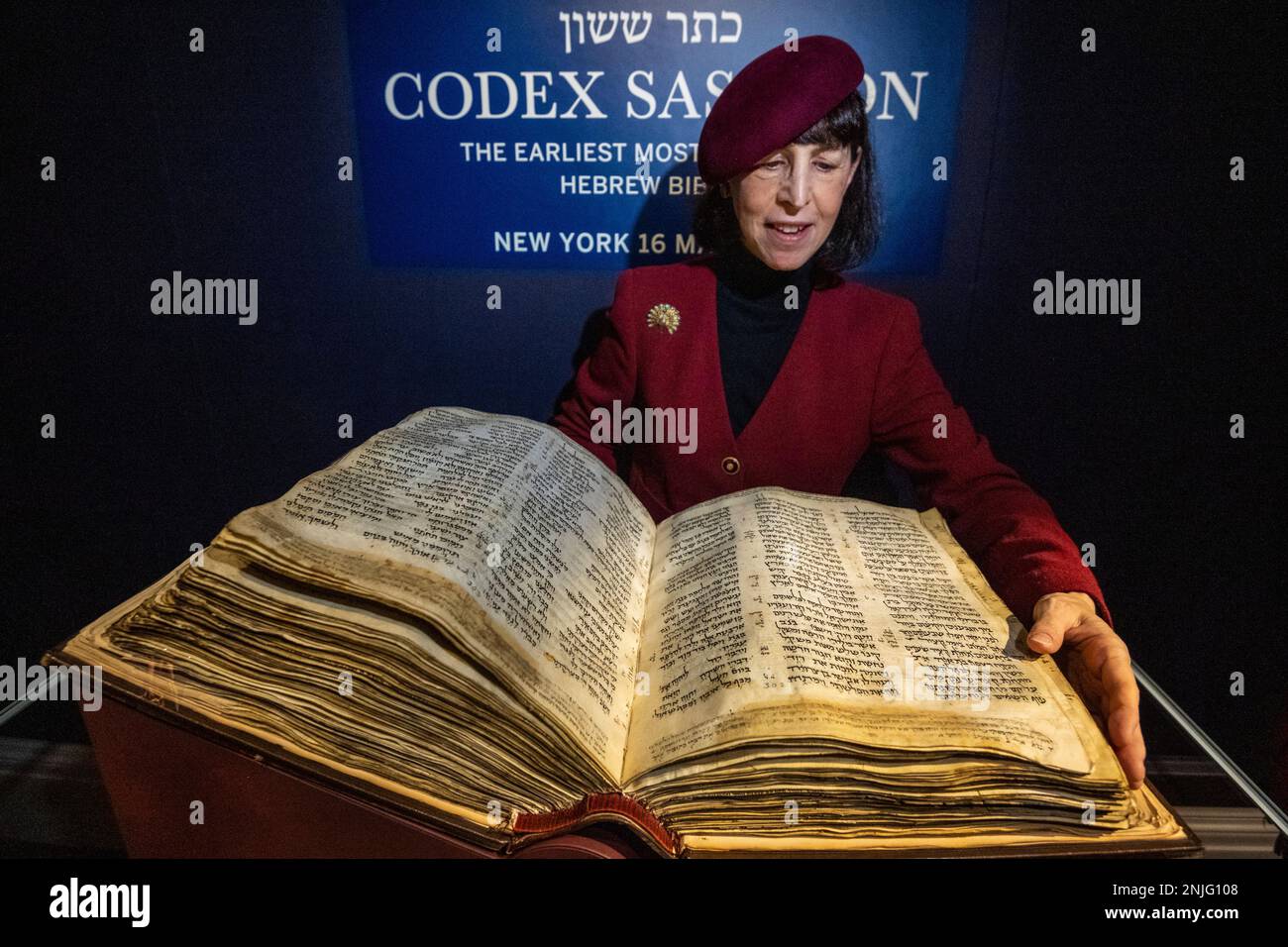 London, UK. 23 February 2023. A staff member presents the earliest and ...