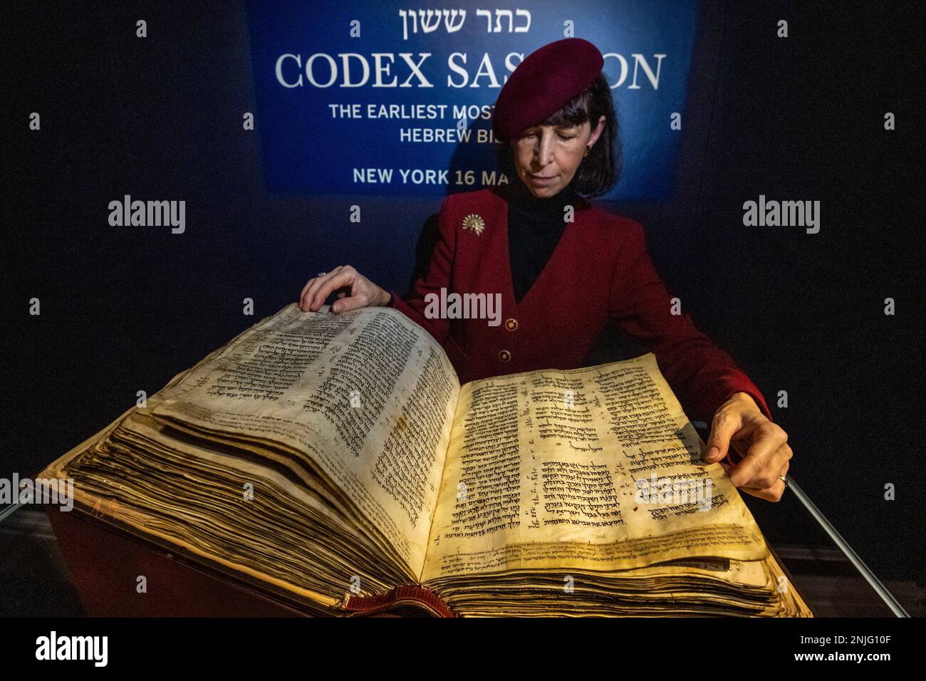 London, UK. 23 February 2023. A staff member presents the earliest and ...