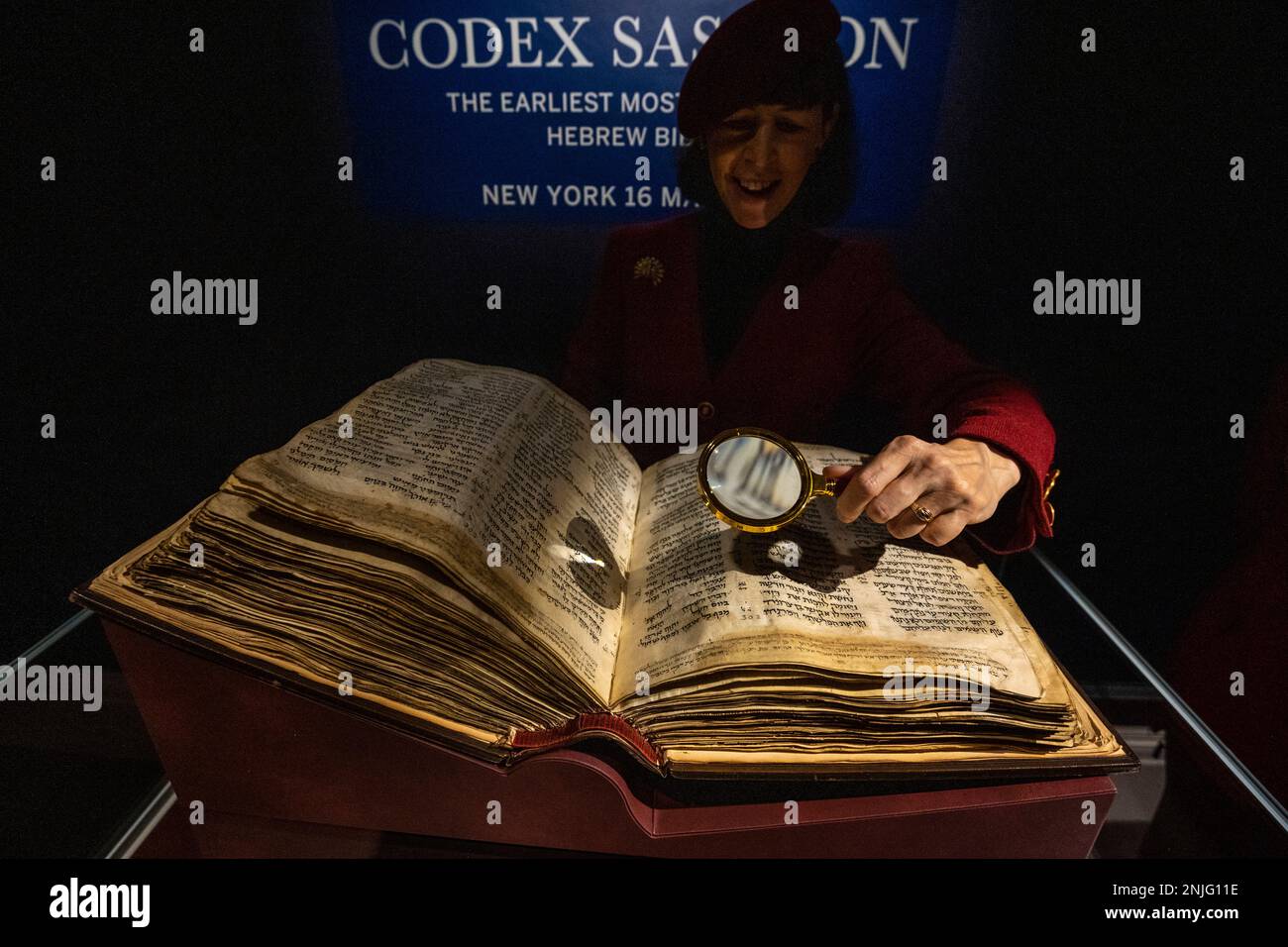 London, UK. 23 February 2023. A staff member presents the earliest and ...
