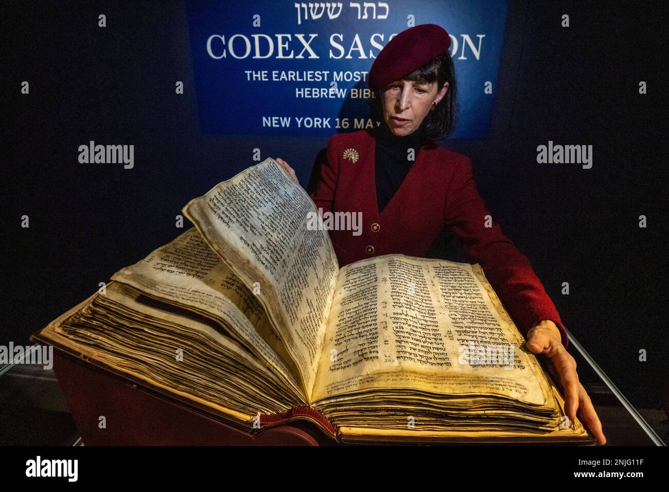 London, UK. 23 February 2023. A staff member presents the earliest and ...