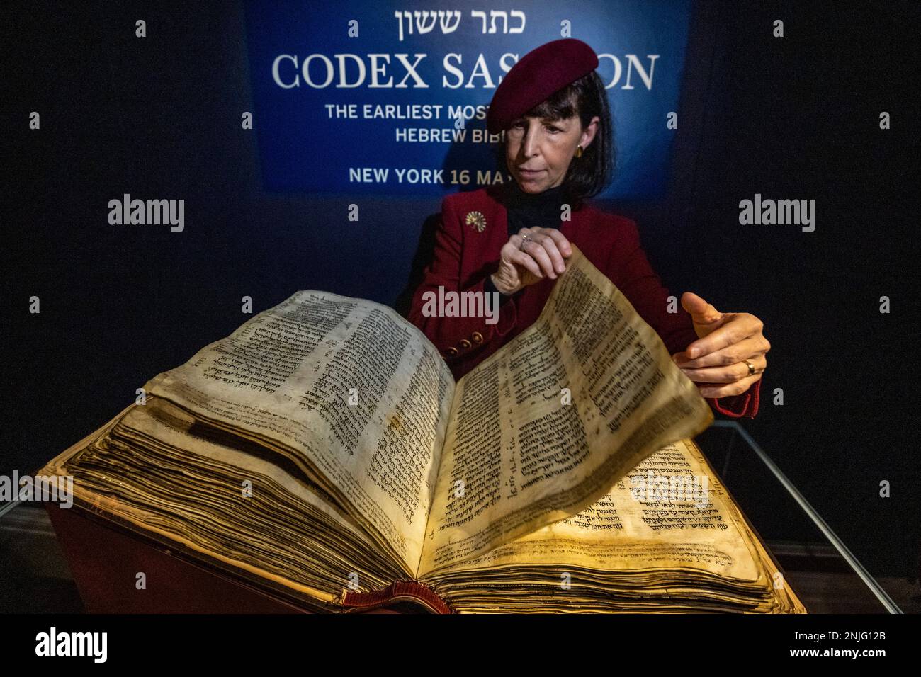London, UK. 23 February 2023. A staff member presents the earliest and ...