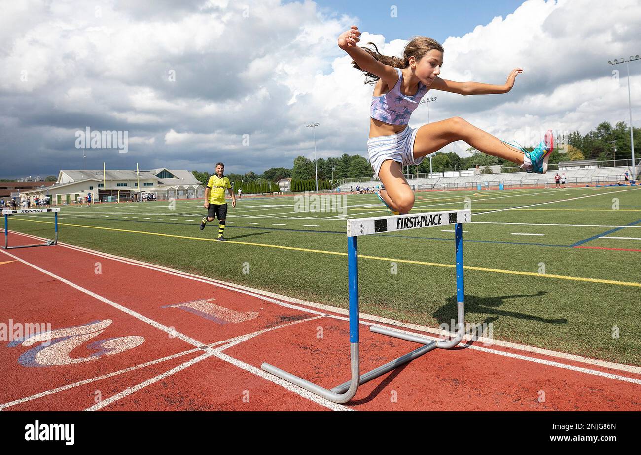 Vanessa Halilaj, 10, clears a hurdle while practicing track and field ...