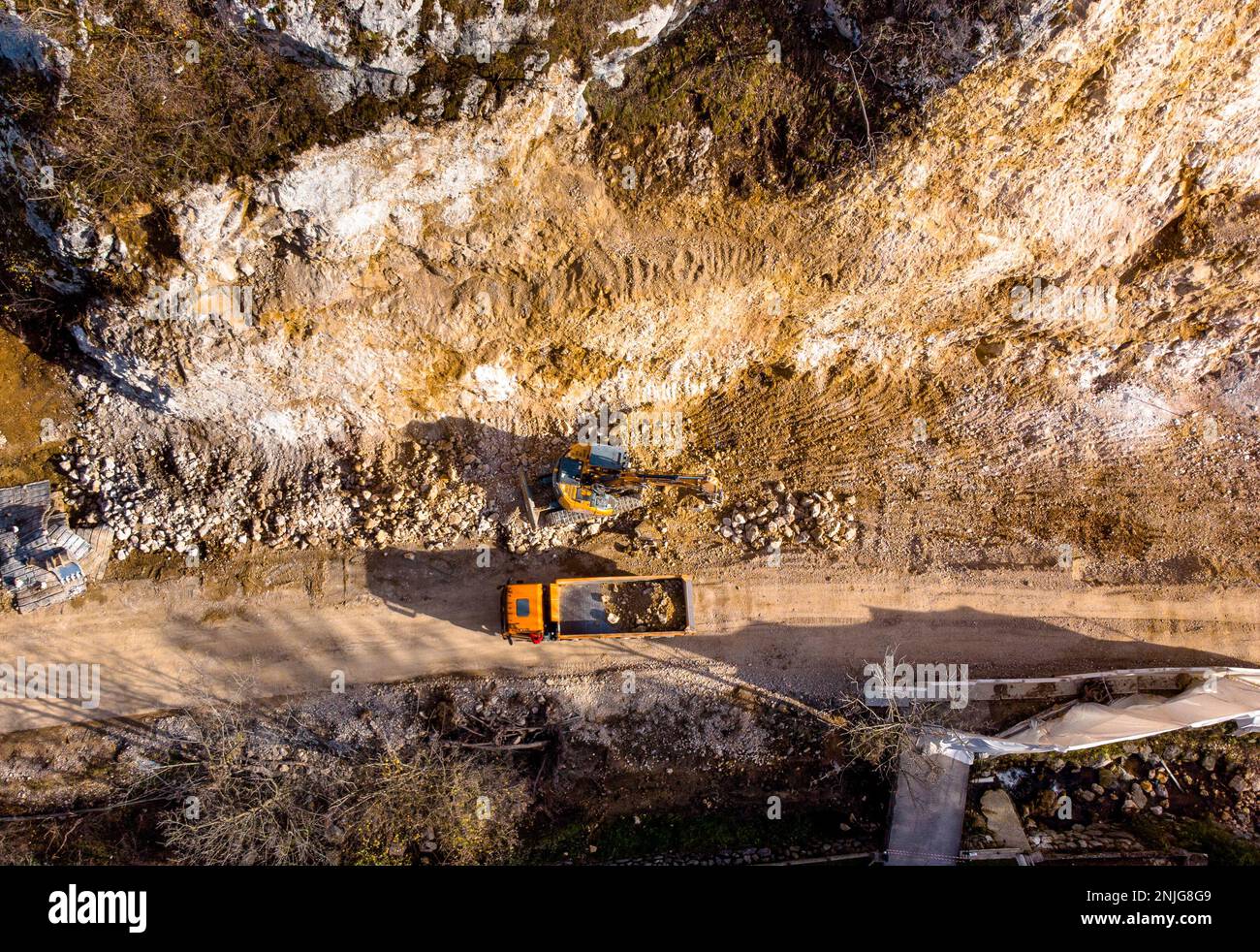Aerial view of a road construction / rebuild on a mountain pass. Side ...