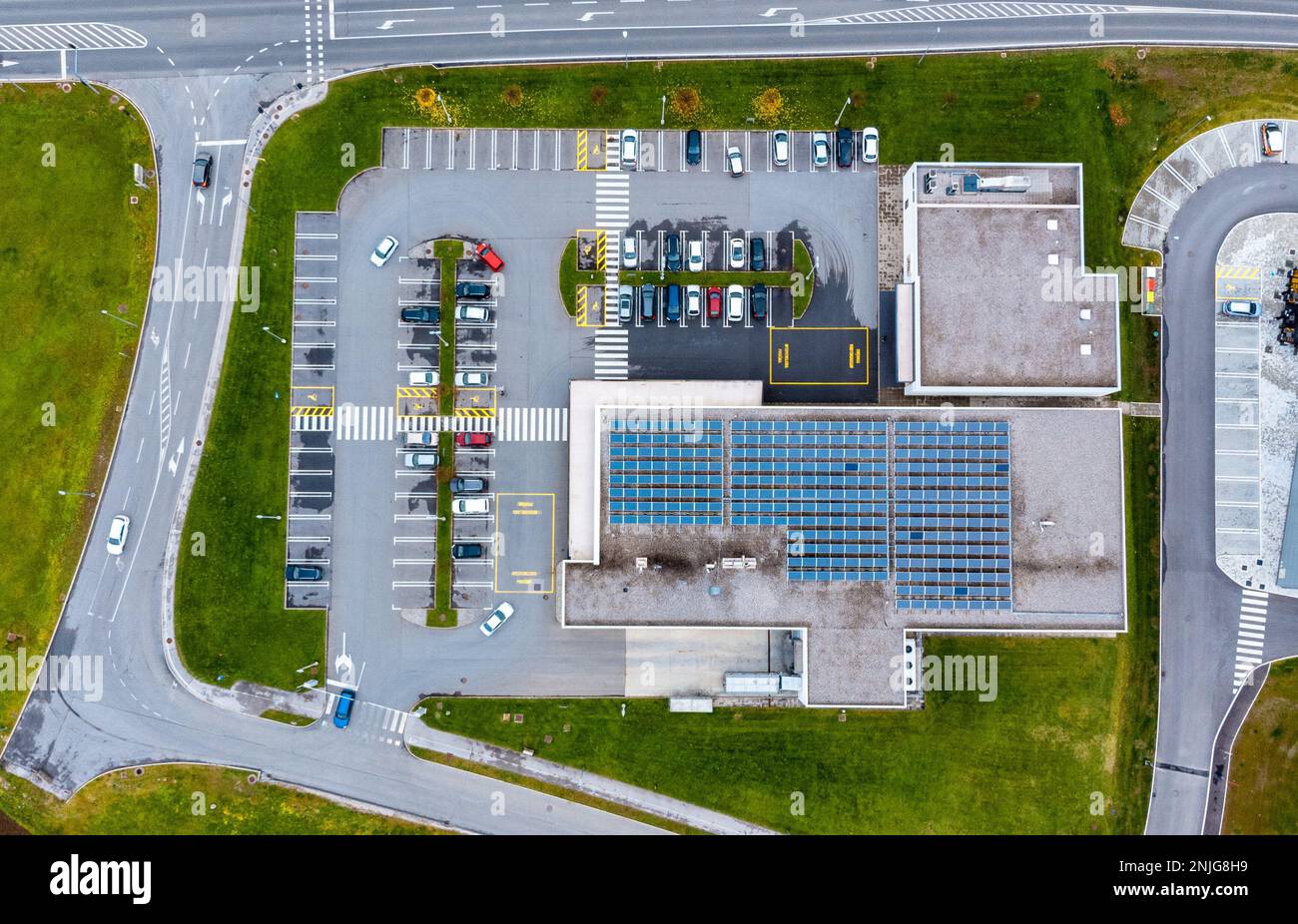 Drone top down view of a commercial building with solar panels on roof ...