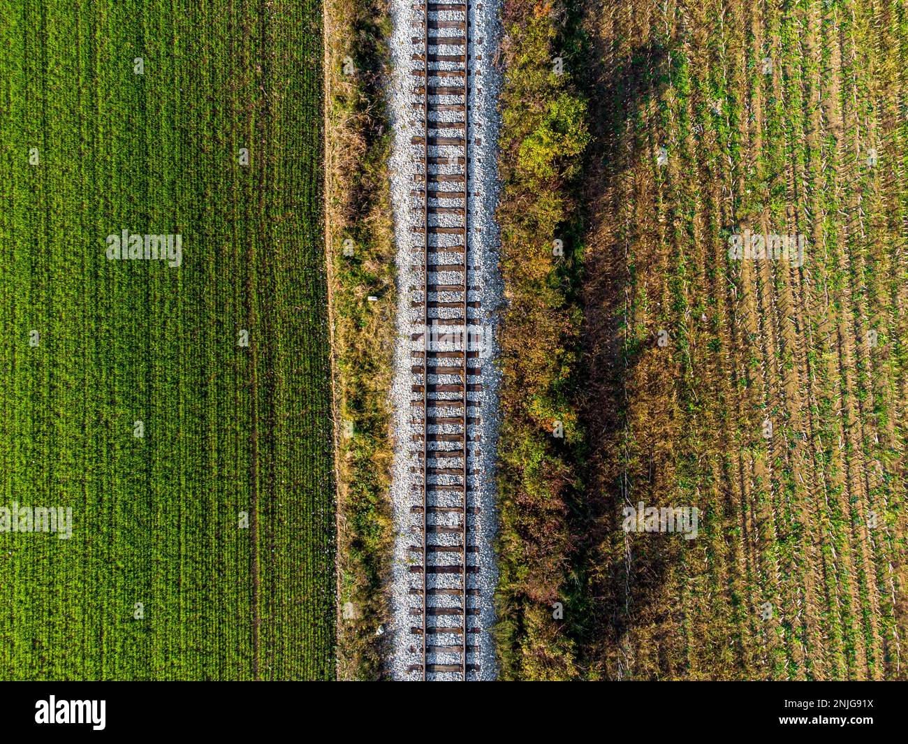 Drone photo of the railroad tracks in the countryside. On the left and ...