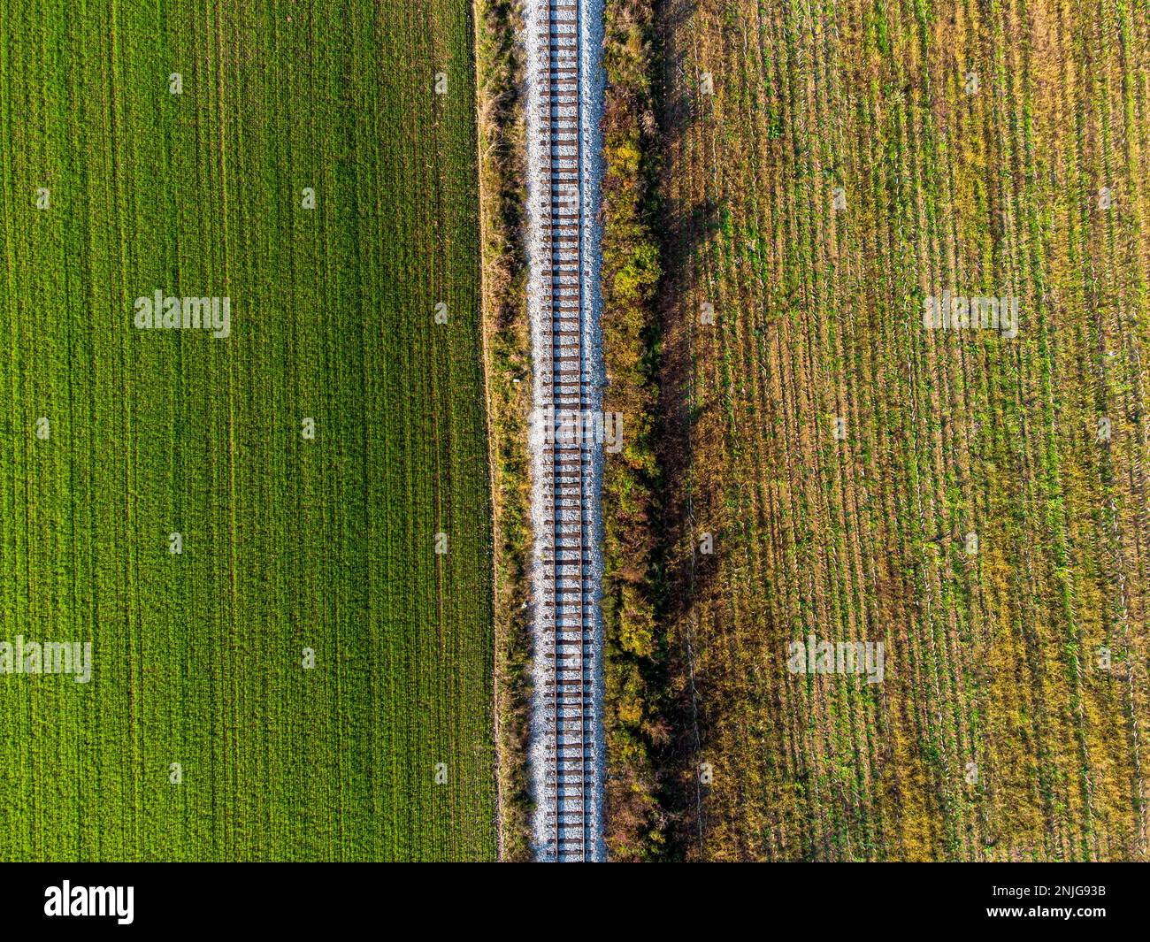 Drone photo of the railroad tracks in the countryside. On the left and ...