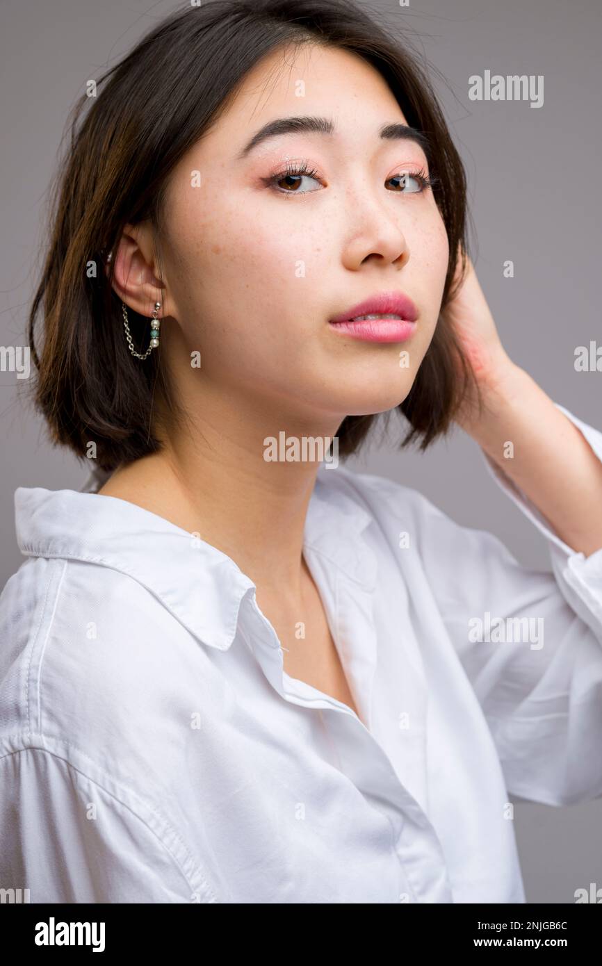 Close up of Beautiful Young Asian Woman in a White Shirt Blouse | Plain White Backdrop Stock ...