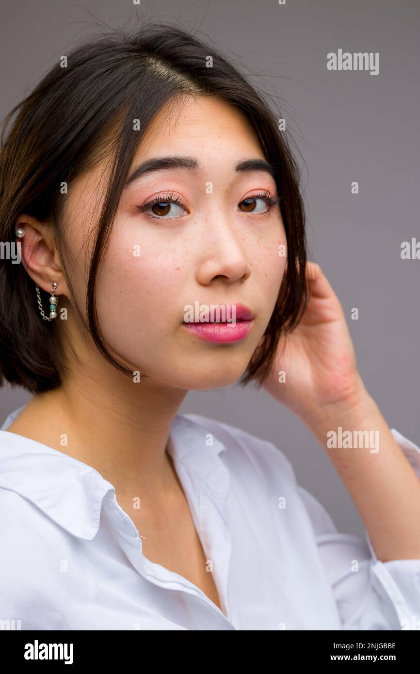 Close up of Beautiful Young Asian Woman in a White Shirt Blouse | Plain White Backdrop Stock ...