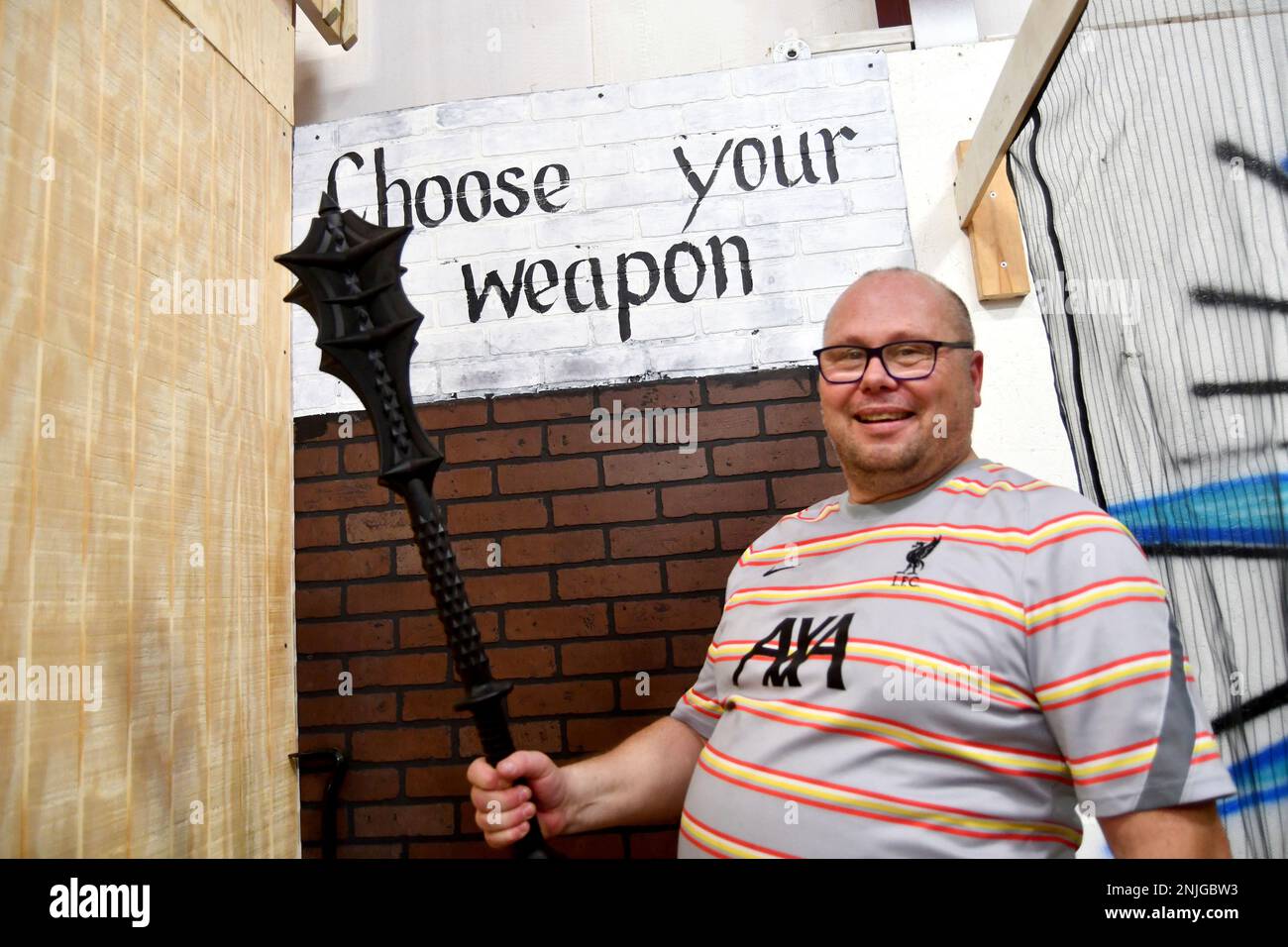 David Jones holds a medieval-style weapon that participants can use to ...