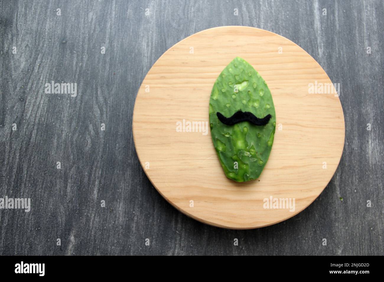 Nopal face with mustache and bow tie festive mexican style on wooden ...