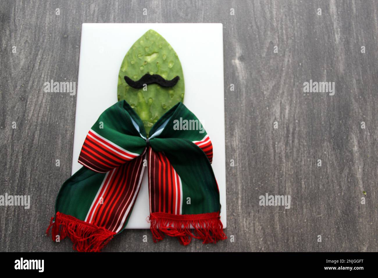 Nopal face with mustache and bow tie festive mexican style on wooden ...