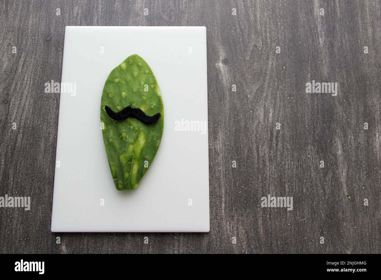 Nopal face with mustache and bow tie festive mexican style on wooden ...