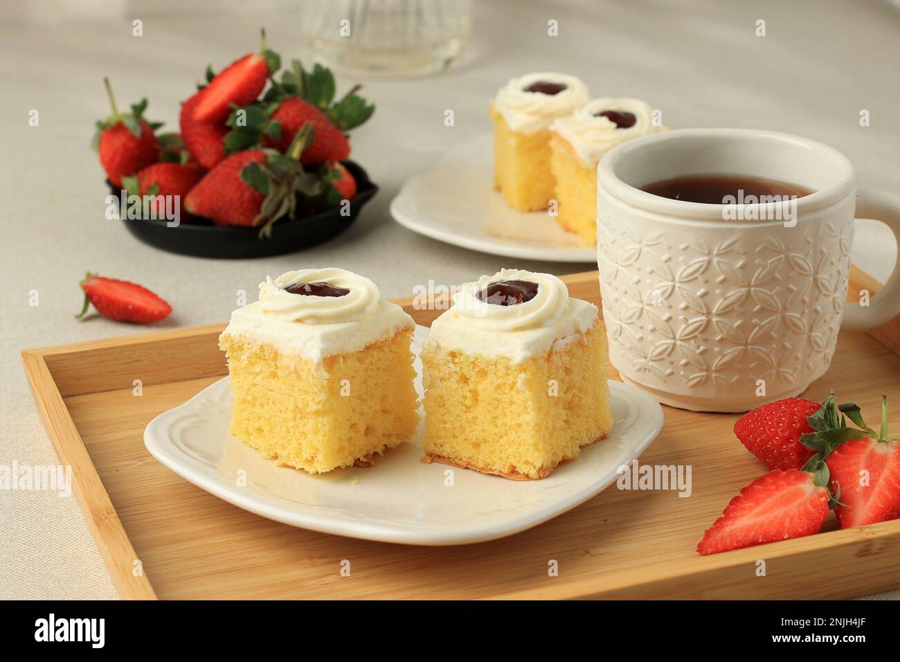 Vanilla Sponge Slice Cake with Strawberry Jam Topping, Served with Tea ...