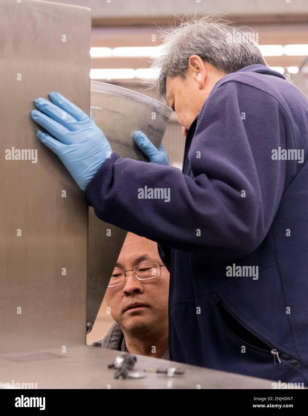 BART engineers work to install a new prototype fare gate at the ...