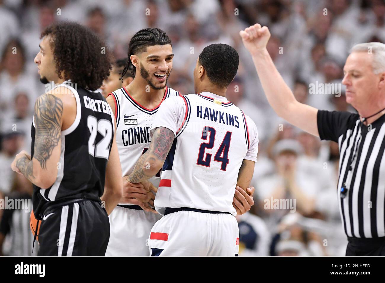 UConn's Andre Jackson Jr., center left, smiles as he grabs teammate ...