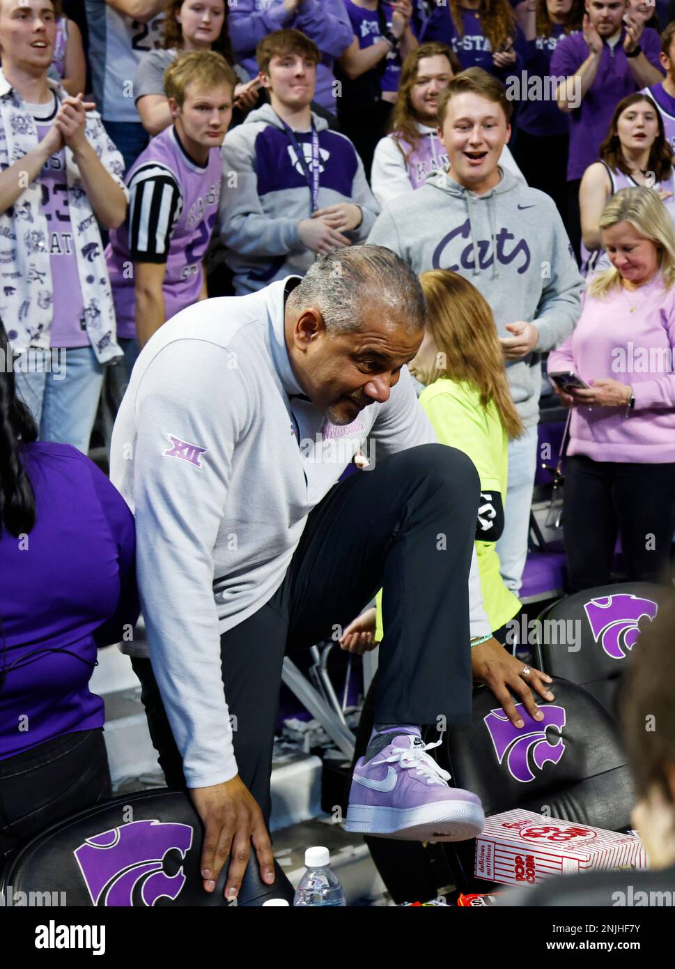 Kansas State head coach Jerome Tang, center, climbs out of the stands ...
