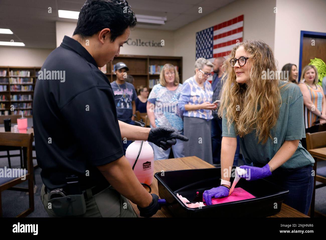 Dr. Sam Antar watches math Teacher Kate Isaac pack and apply pressure ...