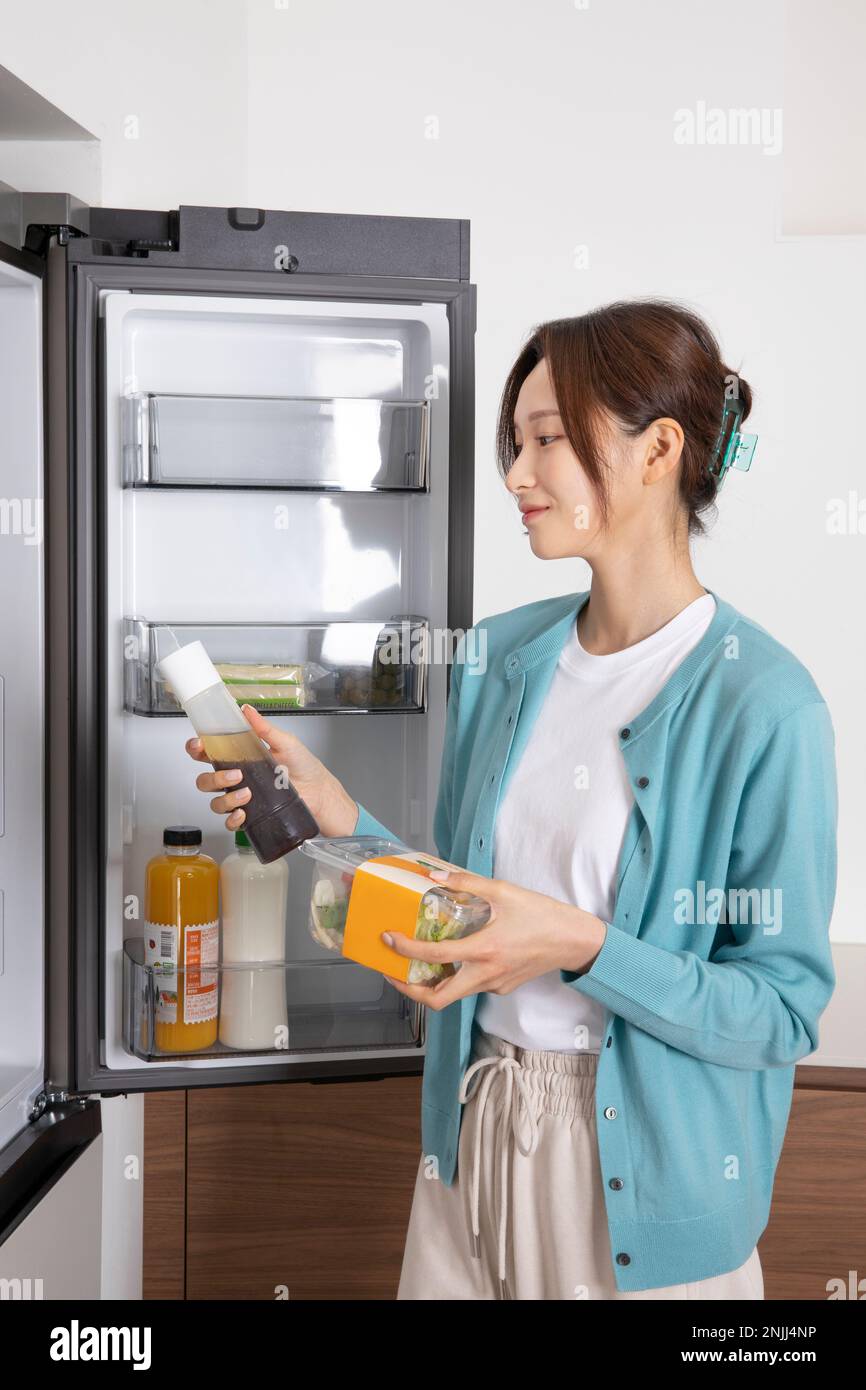 happy single life of korean woman look inside the fridge Stock Photo ...