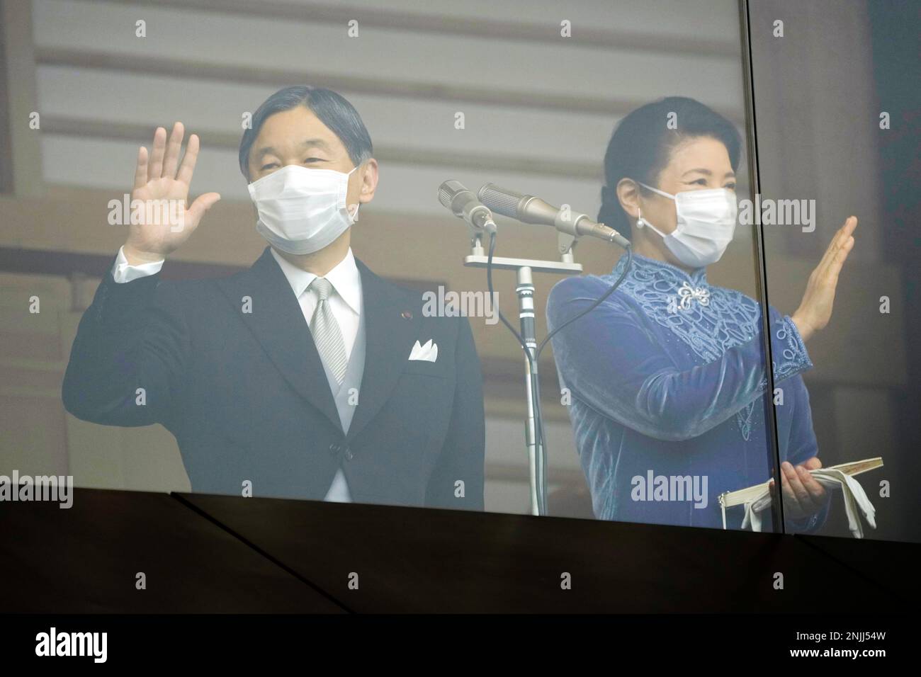 Japan's Emperor Naruhito, left, and Empress Masako wave towards well ...