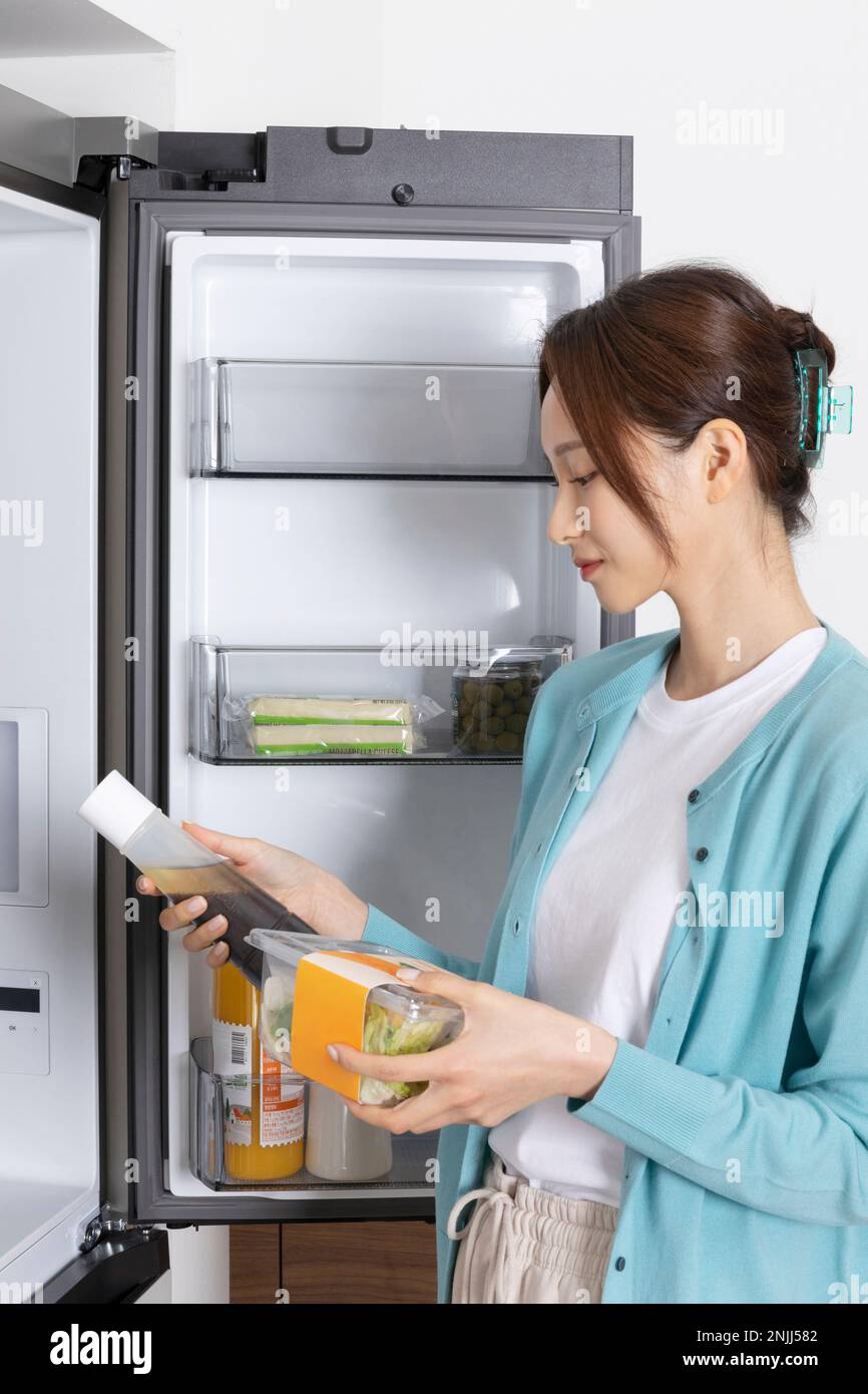 happy single life of korean woman look inside the fridge Stock Photo ...