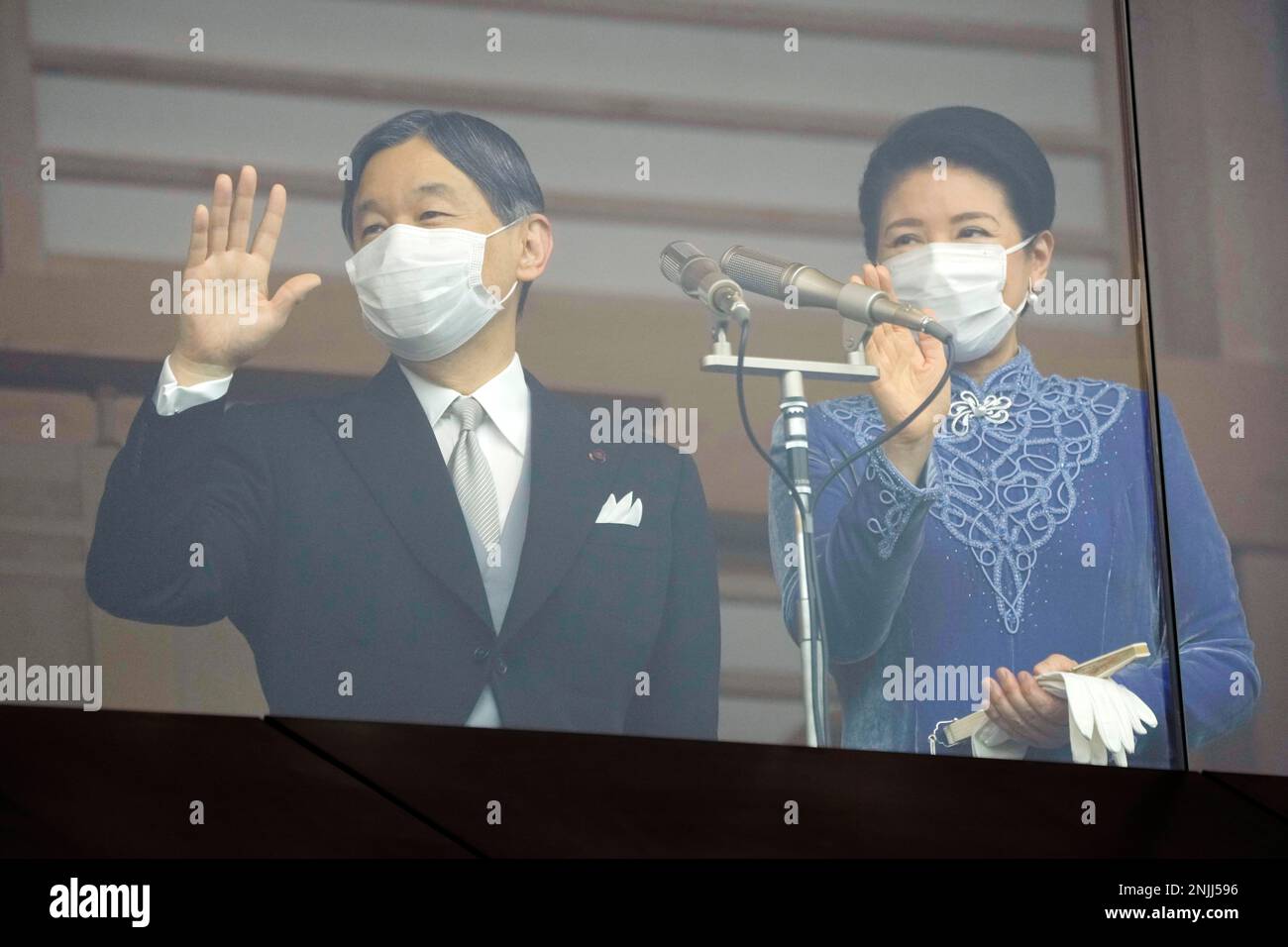 Japan's Emperor Naruhito, left, and Empress Masako wave towards well ...
