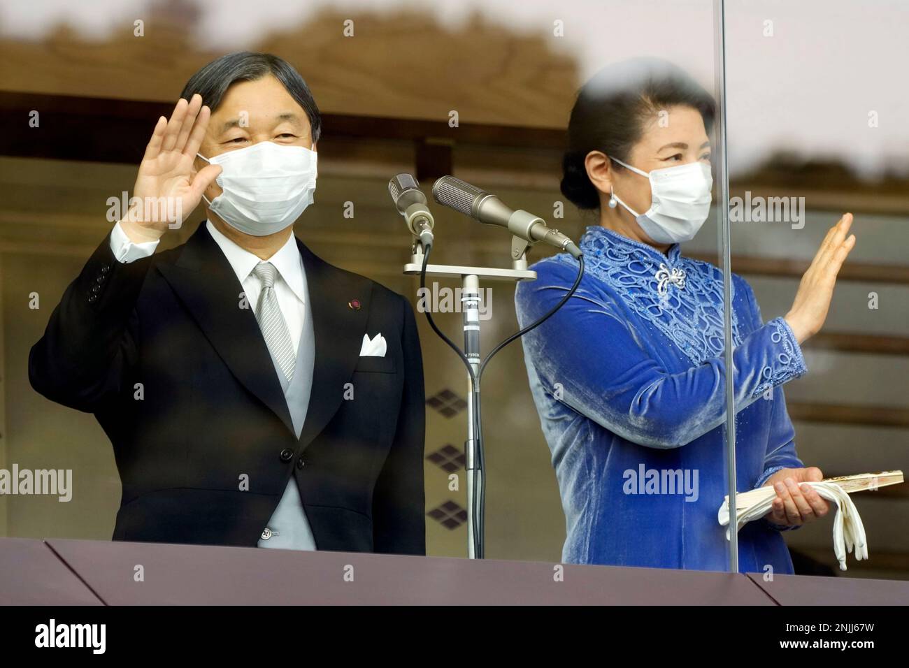 Japan's Emperor Naruhito, left, and Empress Masako wave towards well ...