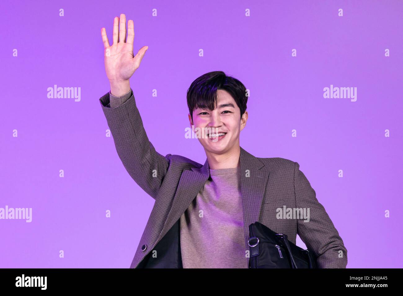 handsome Korean young man leaving work on time with briefcase Stock ...