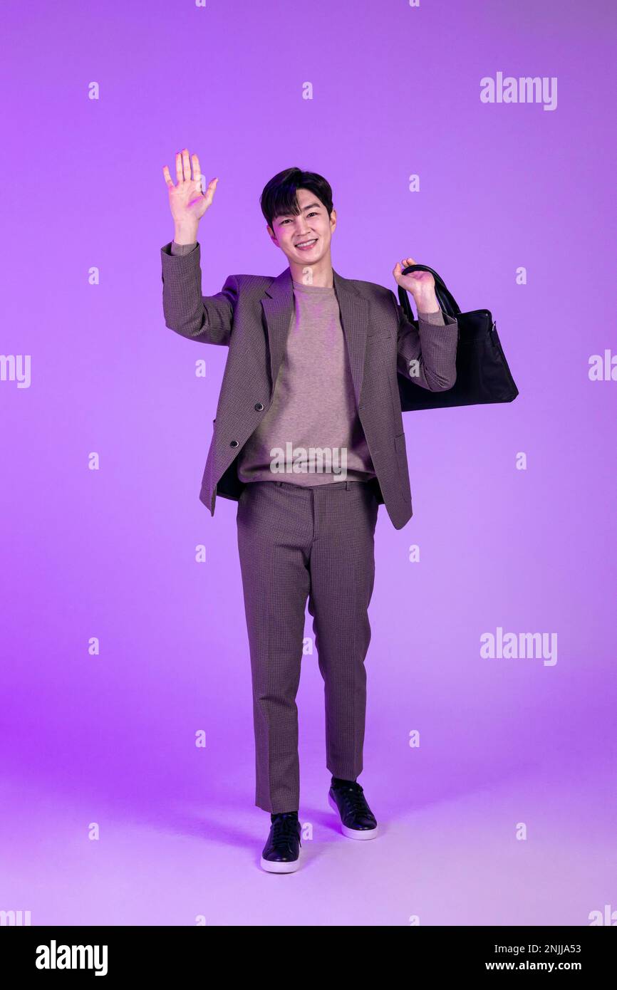 handsome Korean young man leaving work on time with briefcase Stock ...
