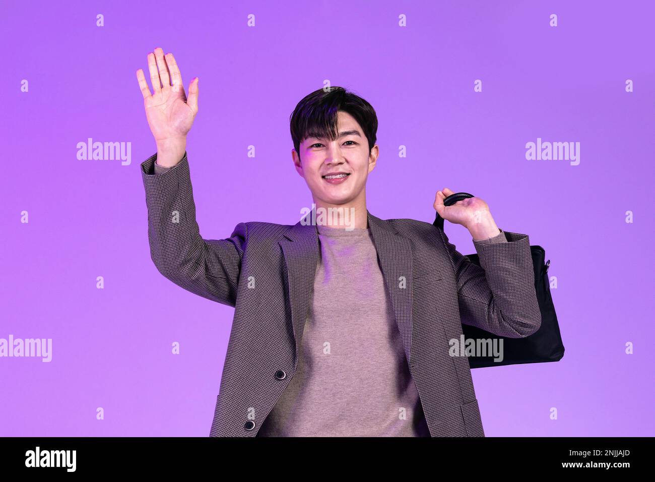 handsome Korean young man leaving work on time with briefcase Stock ...