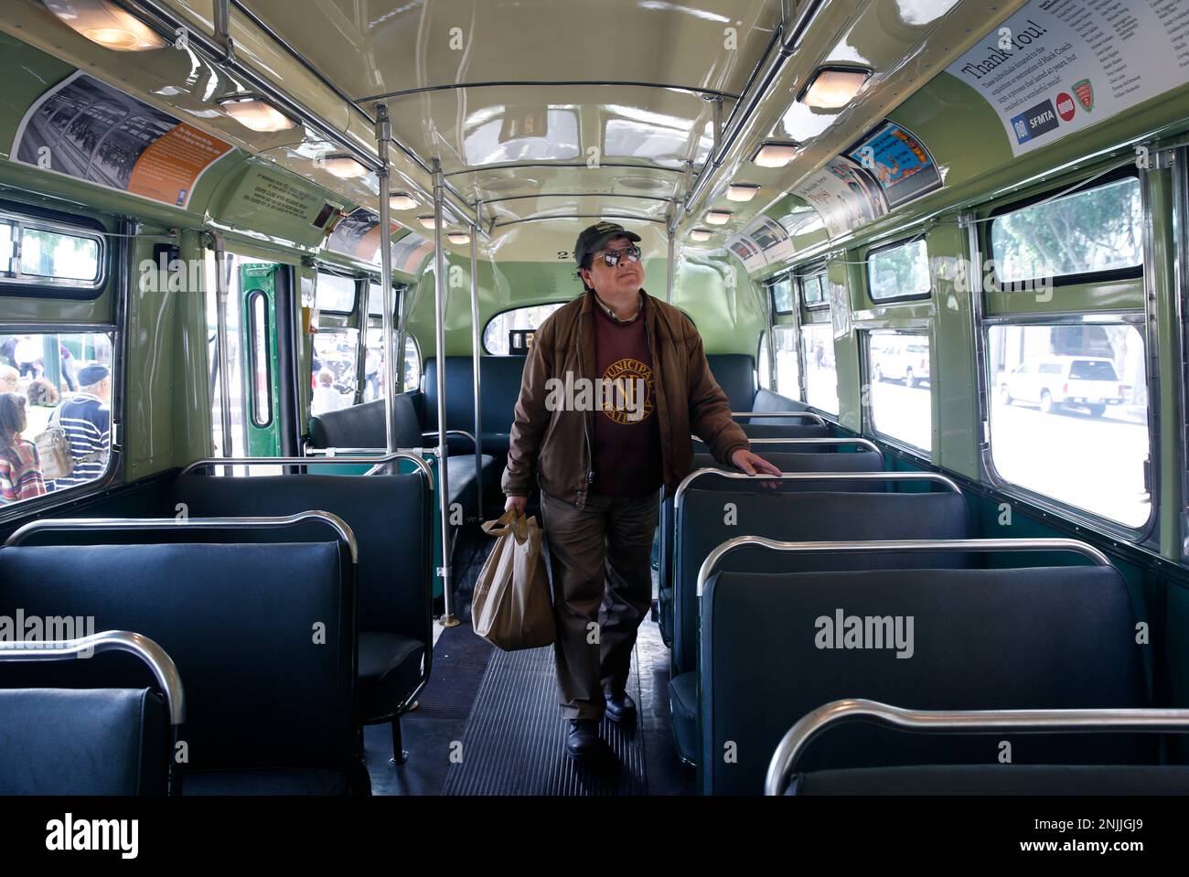 Bill Wong explores the interior of a 1956 Mack bus during the Muni ...