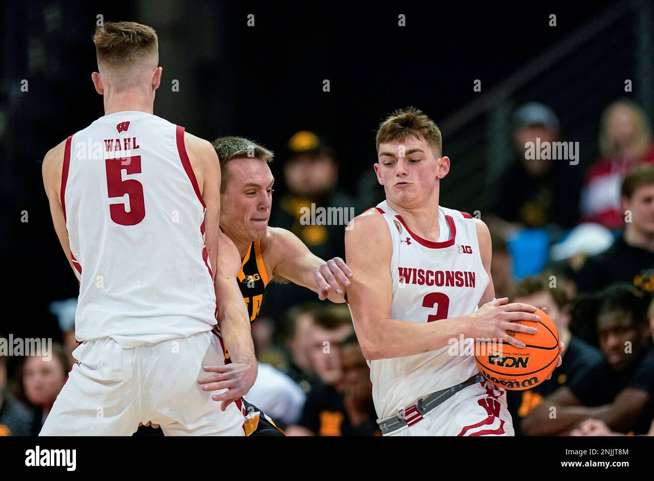 Wisconsin's Connor Essegian (3) drives against Iowa's Payton Sandfort ...