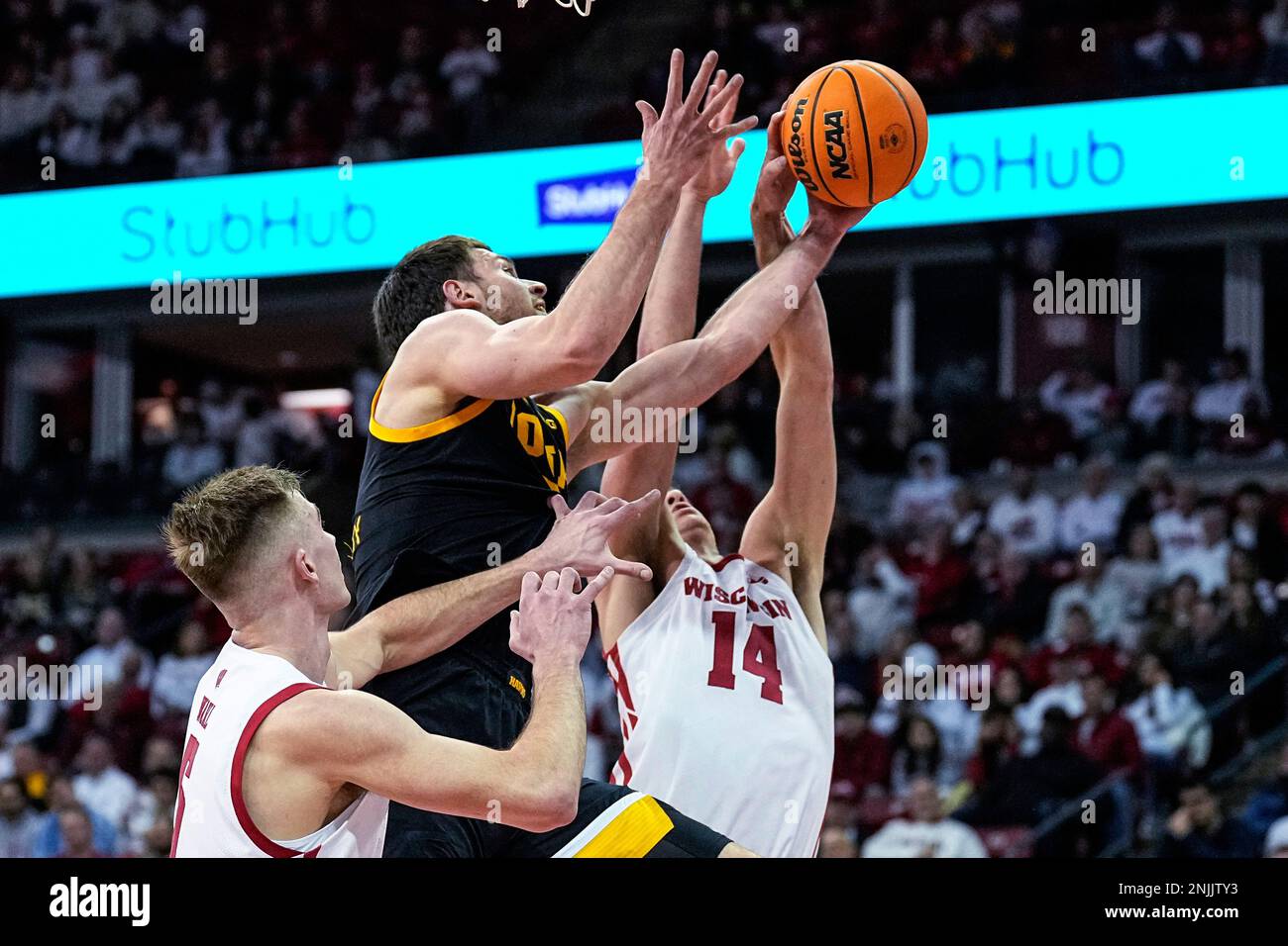 Iowa's Filip Rebraca shoots against Wisconsin's Tyler Wahl (5) and ...