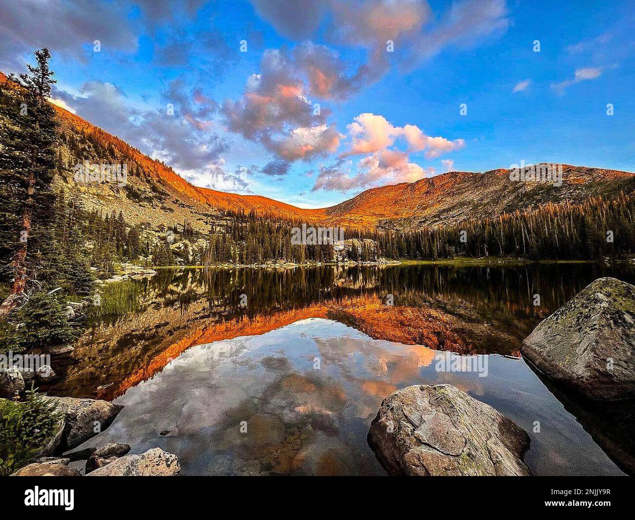 Aplen glow reflects on an apline lake in the Holy Cross Wilderness ...